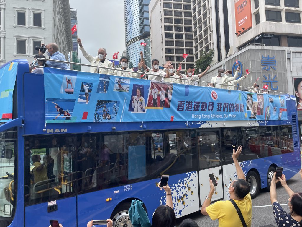 Sports fans cheer and wave to Hong Kong Tokyo Olympic team during ...